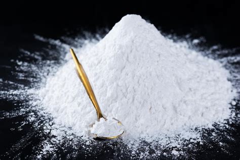 Premium Photo Heap Of Tapioca Starch Powder With Spoon On A Black