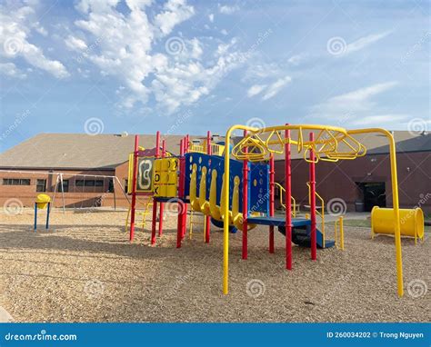 Colorful Typical Playground Structure Under Sunny Blue Cloud Sky At