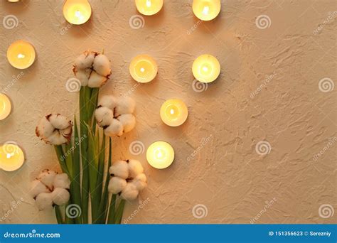 Beautiful Composition With Burning Candles And Cotton Flowers On White