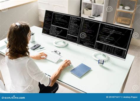 a female programmer typing source codes and using mobile phone in a
