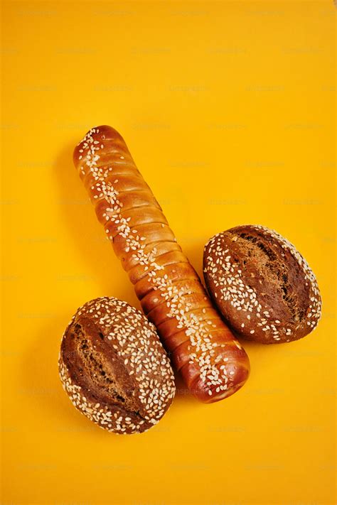 A Couple Of Breads Sitting On Top Of A Yellow Table Photo Sex Image On Unsplash