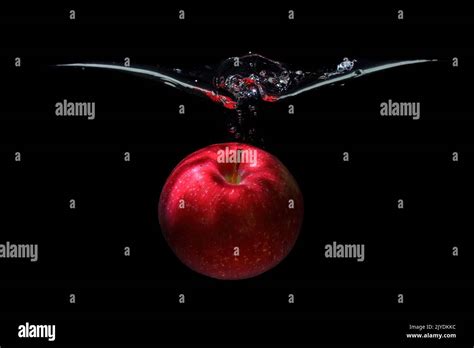 Red Apple Dropped In Water With Splashes Isolated On Black Background Stock Photo Alamy