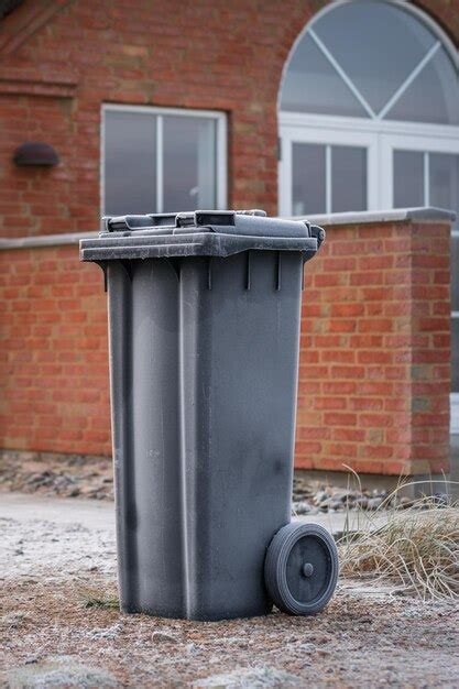 Premium Photo Garbage Bin Against Building