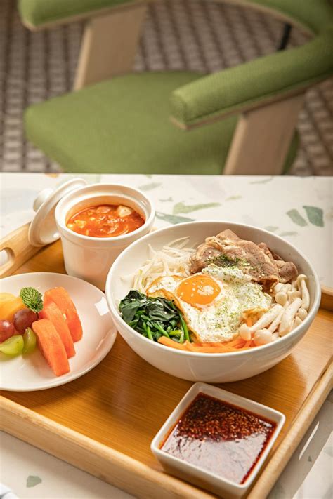 건강한 식생활 계란 고명 국수 균형 잡힌 식단 녹색 의자 다채로운 단백질 도금 접시 레스토랑 많은 맛있는 멜론 모던 다이닝 미식가 비빔밥 서빙
