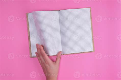 Empty Open Notebook In A Cell And A Female Hand Stock Photo At Vecteezy