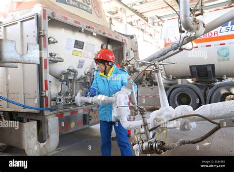 A Worker Connect The Pipe To A Tanker At The LNG Storage Facilities Run By PetroChina In Rudong