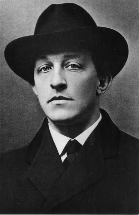 An Old Black And White Photo Of A Man Wearing A Hat