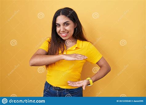 Young Arab Woman Standing Over Yellow Background Gesturing With Hands