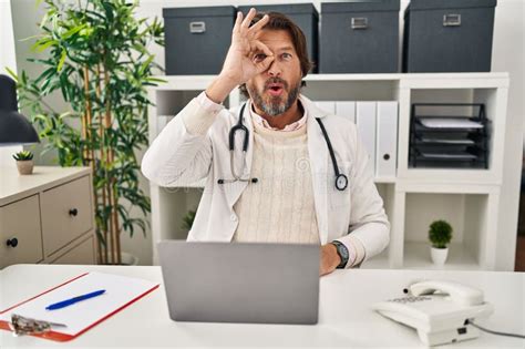 Handsome Middle Age Doctor Man Working At The Clinic Doing Ok Gesture