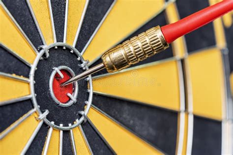 Closeup Red Dart Arrow Hitting In Target Bullseye Of Dartboard Stock Photo Image Of Match