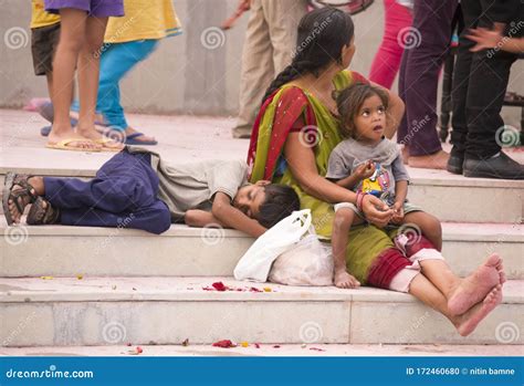 Mother With Her Girl In Lap And Son Sleeping On Stairs Besides Her India Editorial Image