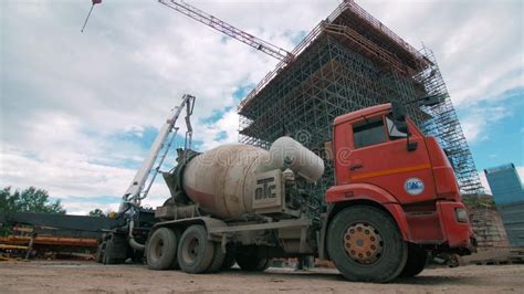 Concrete Mixer Truck Operates Near Metal Carcass Tower Stock Footage