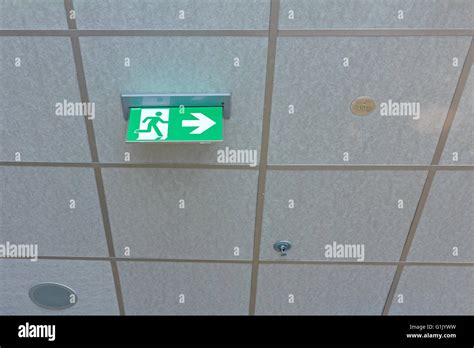 Standard International Symbol Safe Exit Sign Is Hanging From The Ceiling Stock Photo Alamy