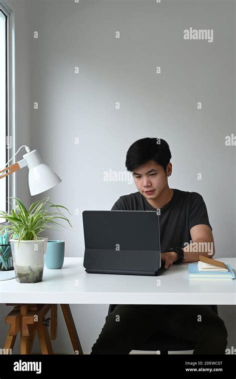 Portrait Of A Freelance Graphic Designer Man Is Working On Computer Tablet At His Modern