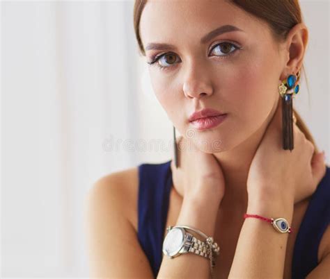 Young Woman Sitting On A Chair Isolated Over White Background Stock