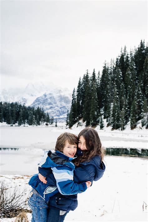 Big Sister Holding And Hugging Her Smaller Brother Outdoors And Both