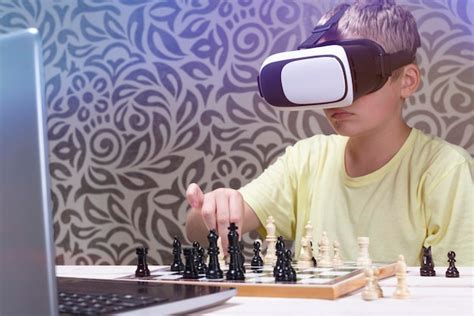 Premium Photo A Boy In A Virtual Reality Headset Plays Chess With A
