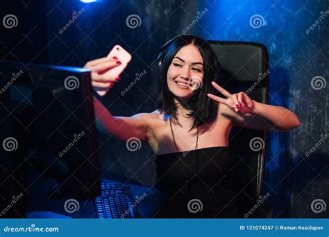 Cheerful Gamer Girl Pointing With Finger At Smartphone With Blank