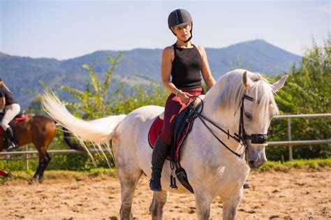 Premium Photo Caucasian Blonde Girl Stroking A White Horse On A