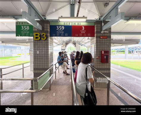 Commuters Queuing In The Designated Bus Number Line Waiting For Their