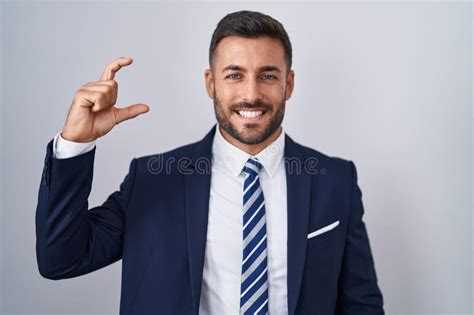 Handsome Hispanic Man Wearing Suit And Tie Smiling And Confident