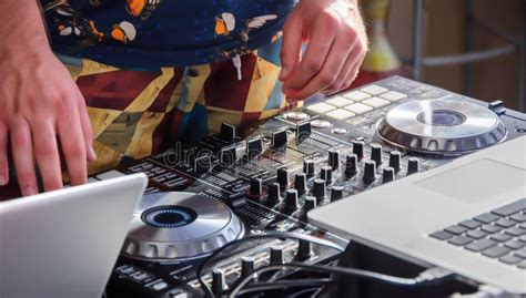 DJ Hands Behind The Remote Control Works To Adjust The Sound Stock