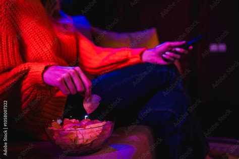 Cropped Photo Of Young Woman Remote Controller Eat Chips Dressed Orange
