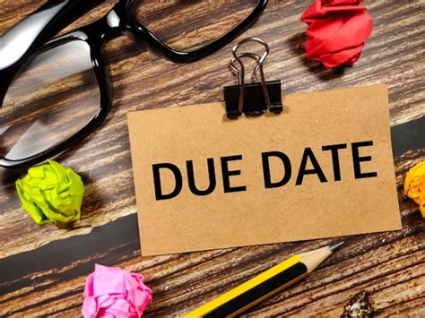 Premium Photo Business Concepttext Due Date Writing On Brown Card With Glassestorn Paper And