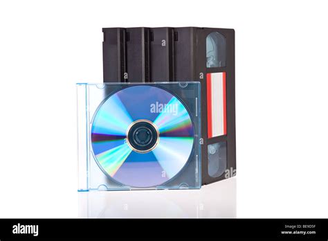 Old Video Cassette Tapes With A Dvd Disc Isolated On White Background