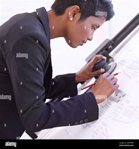 Design Is Her Passion A Female Architect Working On A Building Plan At A Drawing Board Stock