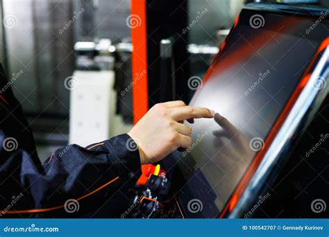 operator adjusts cnc machine using touch screen stock image image of