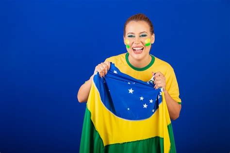 Premium Photo Caucasian Woman Redhead Brazil Soccer Fan Brazilian Blue Background Screaming