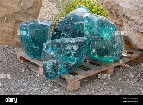 Heap Of Large Chunk Of Aqua Glass Rock Slag On Wooden Industrial Pallet