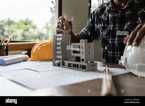 Architect Man Working With Blueprints For Architectural Plan Engineer Sketching A Construction