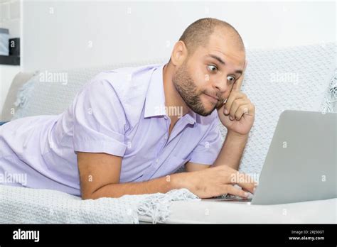 Male Computer Programmer Solving Problem Indoors At Home At Couch Stock