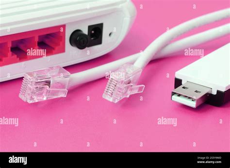 Internet Router Portable Usb Wi Fi Adapter And Internet Cable Plugs Lie On A Bright Pink