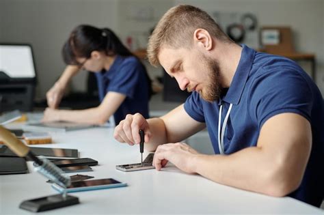 Premium Photo Man Fixing Tiny Details Of Smartphone