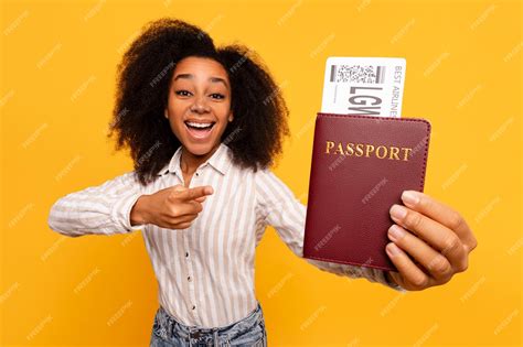 Premium Photo Excited Black Female Traveler Pointing At Passport And