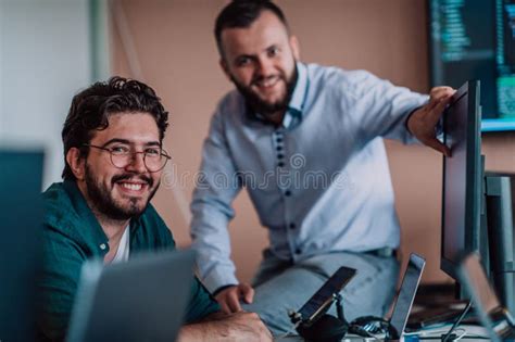 Programmers Engrossed In Deep Collaboration Diligently Working Together To Solve Complex