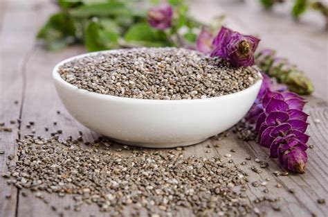 Premium Photo Chia Seeds Healthy Superfood With Flower On Wooden Table