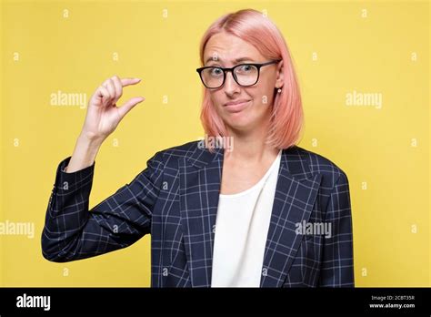 Caucasian Woman Showing Small Amount Of Something With Fingers Stock