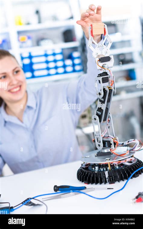 A Girl In A University Laboratory Is Experimenting With A Robot Stock Photo Alamy