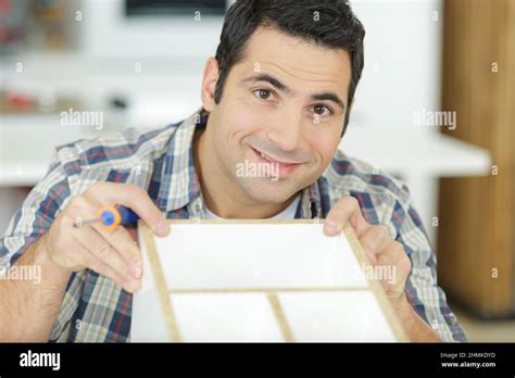 Man Repairing Furniture At Home Stock Photo Alamy