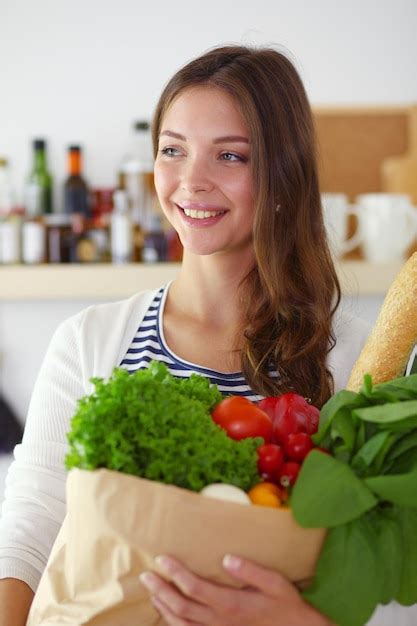 Premium Photo Young Woman Holding Grocery Shopping Bag With Vegetables