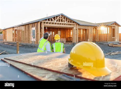 Male And Female Construction Workers At New Home Site Stock Photo Alamy