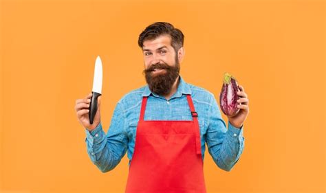 Premium Photo Happy Man In Apron Holding Chefs Knife And Eggplant