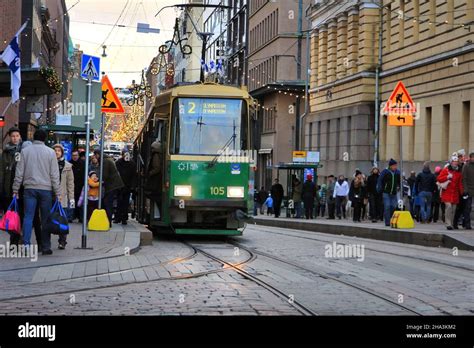 Shoppers And Travelers In Crowded Aleksanterinkatu With Green Hsl Tram