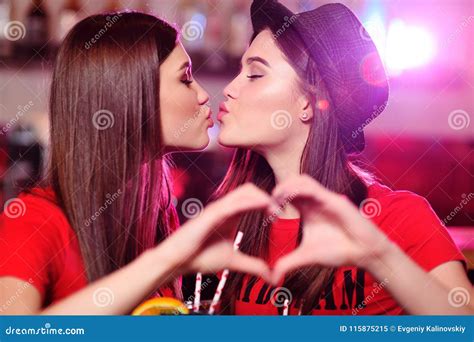Cute Lesbian Girlfriends Kissing On Bar Background At A Party Stock