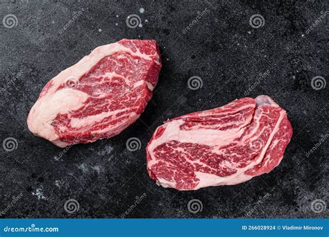 Raw Chuck Eye Roll Steaks Premium Beef Meat On A Butcher Board Black