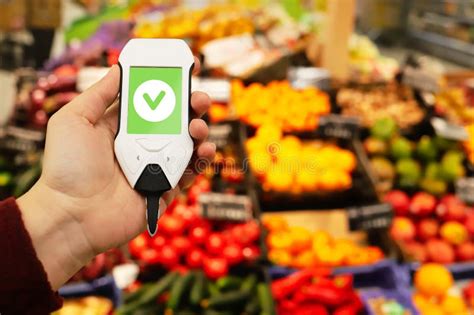 Device In Hand Measuring Nitrates And Pesticides On Market Vegetables And Fruits Stock Photo